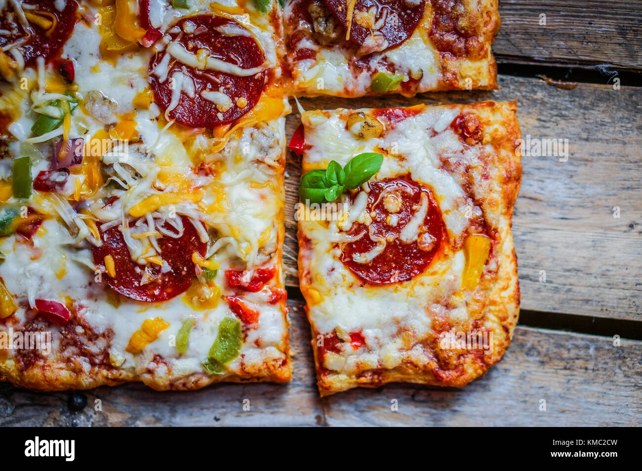 Square Pepperoni Pizza On Rustic Wooden Background Stock Photo - Alamy