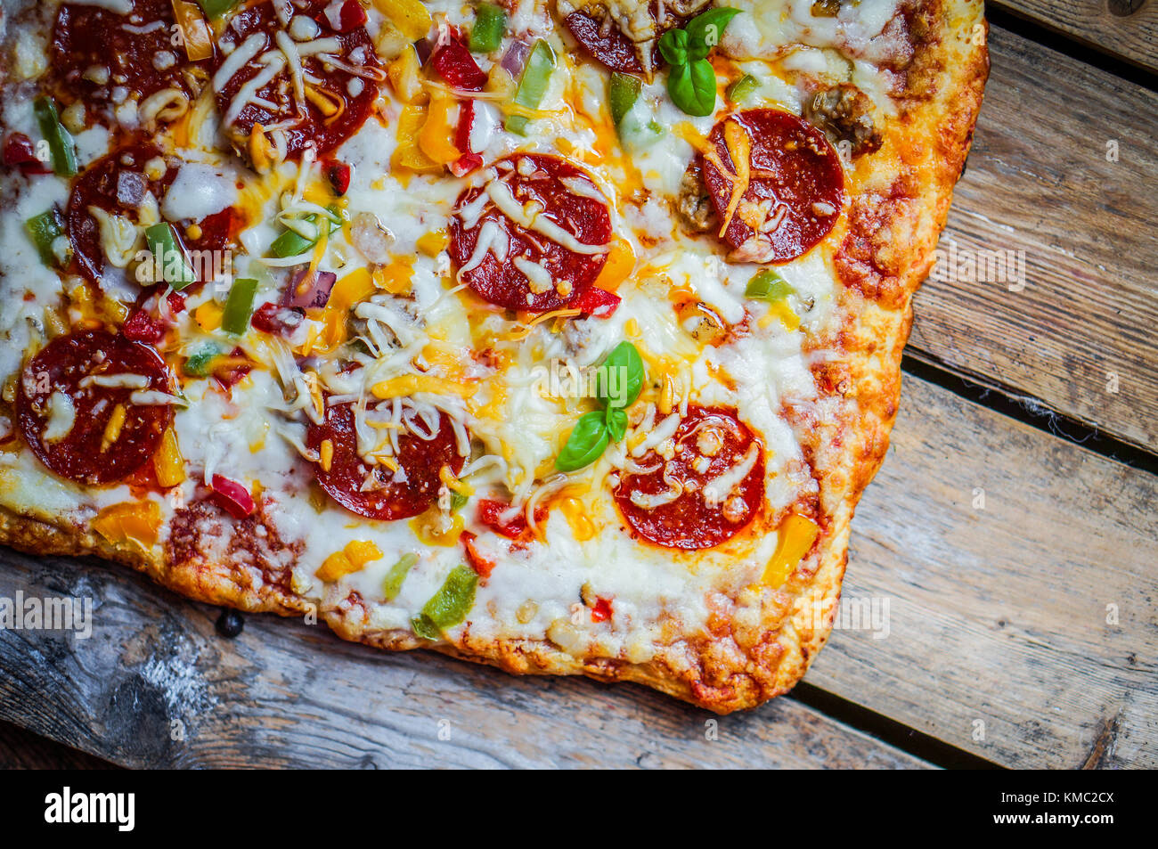 Square Pepperoni Pizza On Rustic Wooden Background Stock Photo - Alamy