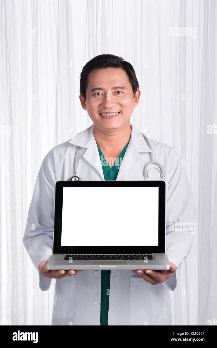 Male doctor with laptop in hands in a hospital Stock Photo - Alamy