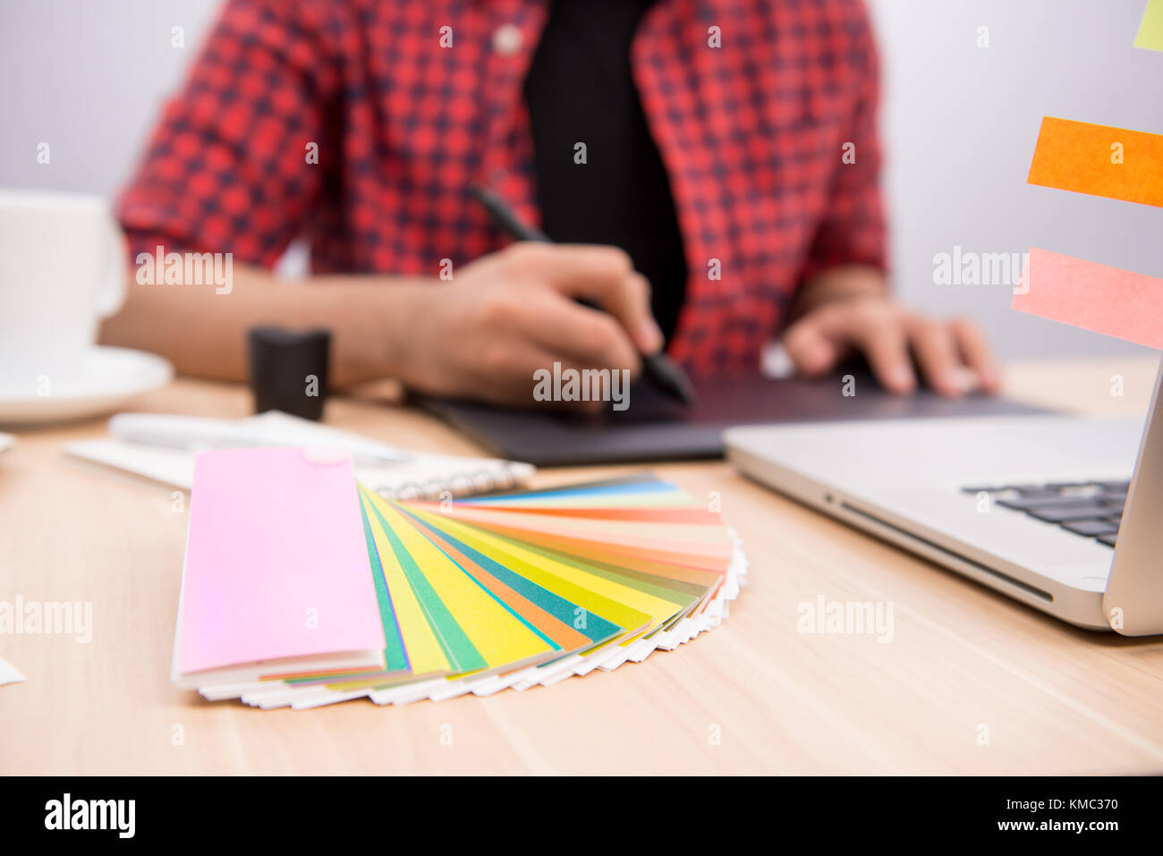 Happy designer working on his laptop in creative office Stock Photo - Alamy