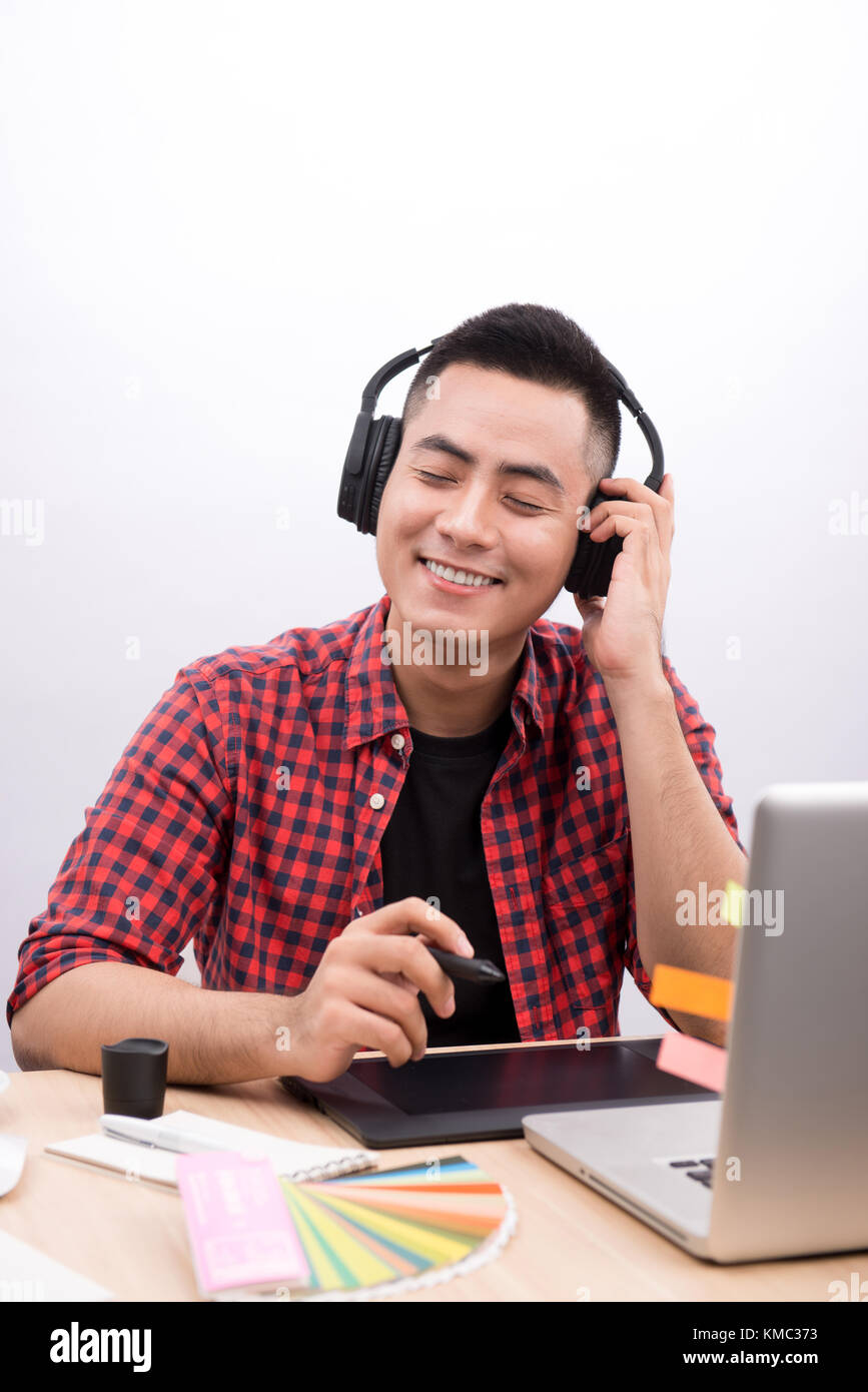 Happy designer working on his laptop in creative office Stock Photo - Alamy