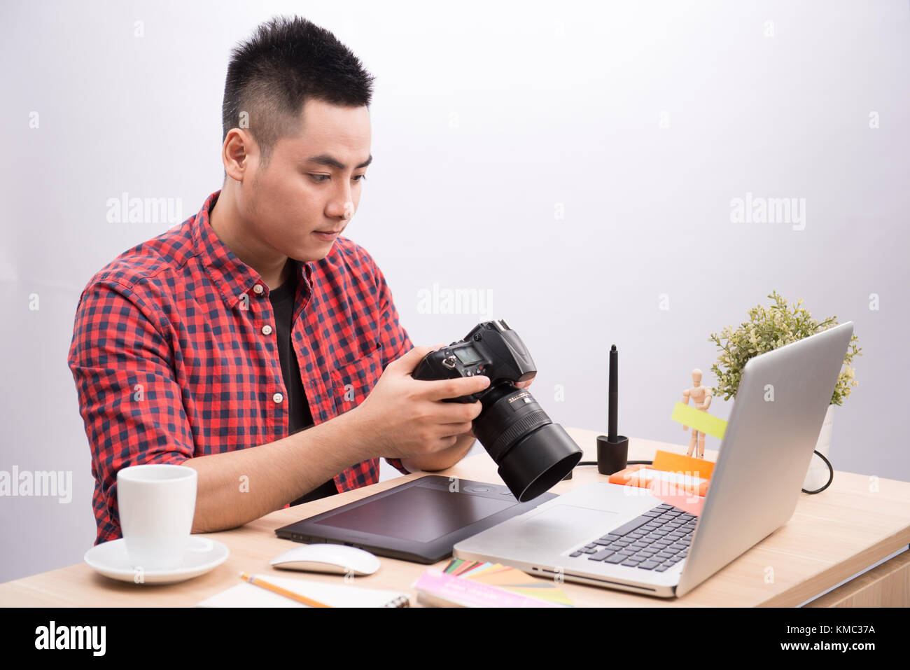 Professional photographer. Portrait of confident young man in shirt ...