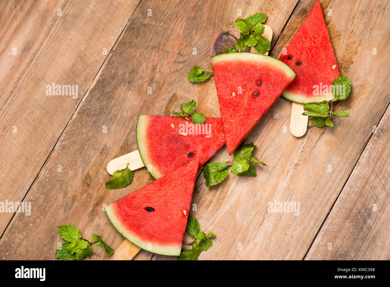 Watermelon slices on sticks. Watermelon popsicle on wooden white ...