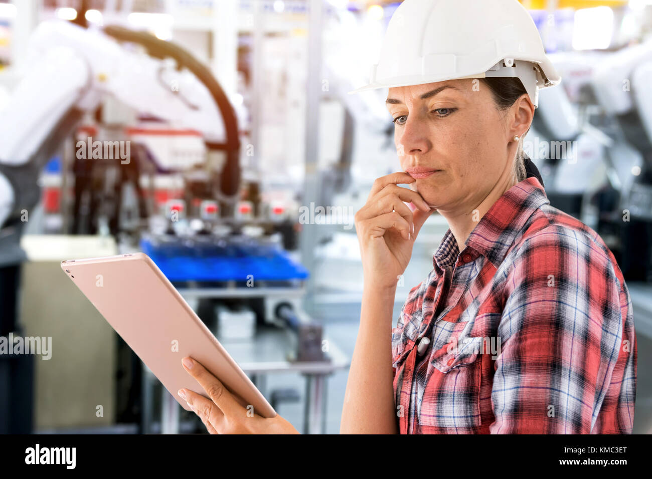 Female Engineer Using Tablet With Machine Real Time Monitoring System Software Blur Automation