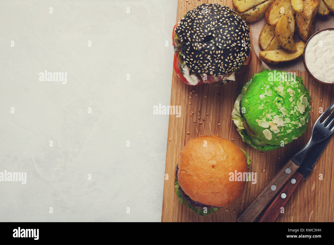 set of three mini homemade Burger with marble beef and vegetables on a ...