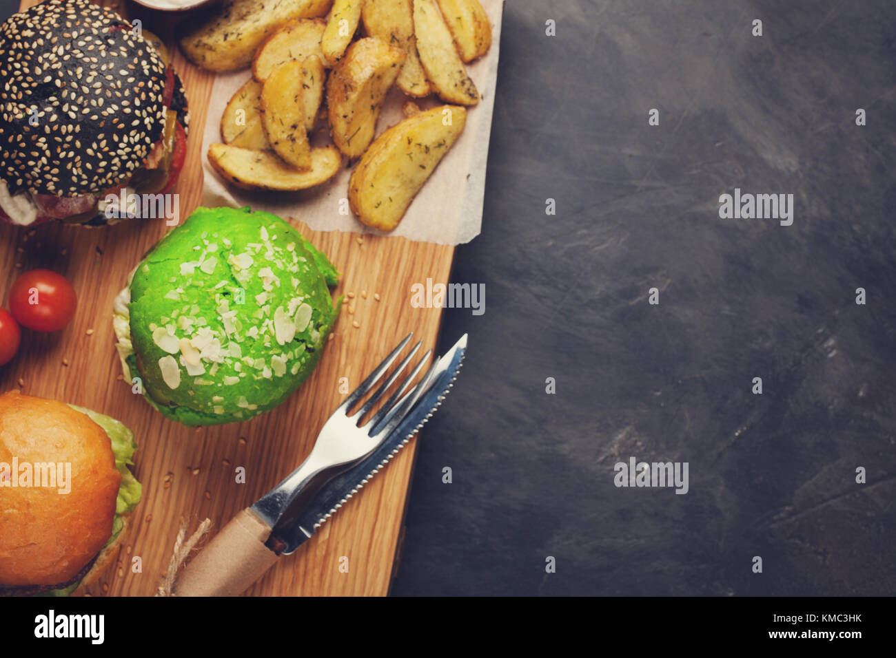 set of three mini homemade Burger with marble beef and vegetables on a ...