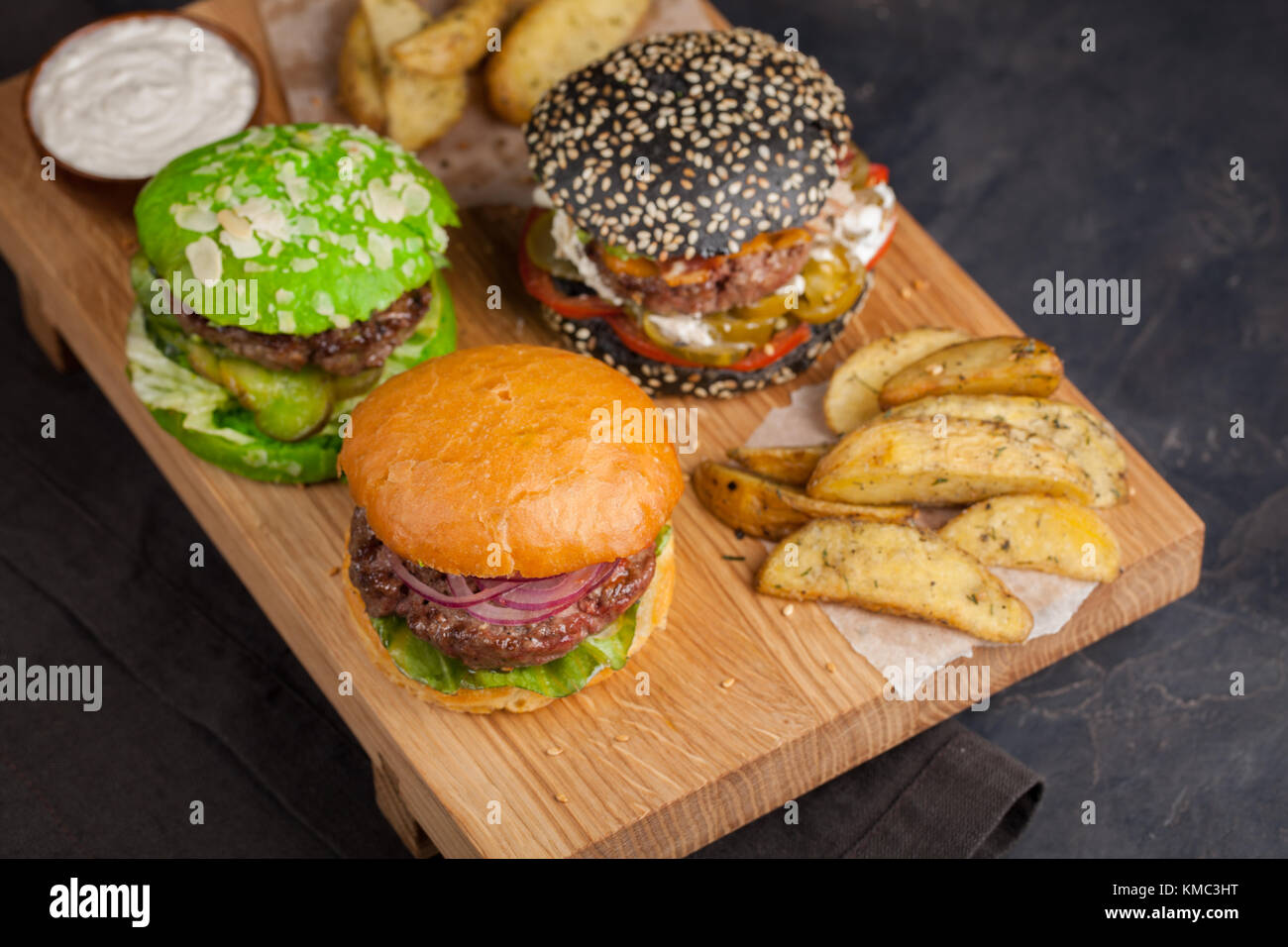 set of three mini homemade Burger with marble beef and vegetables on a ...