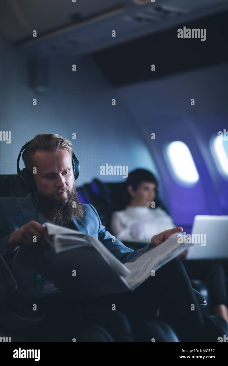 Reading newspaper in airplane hi-res stock photography and images - Alamy