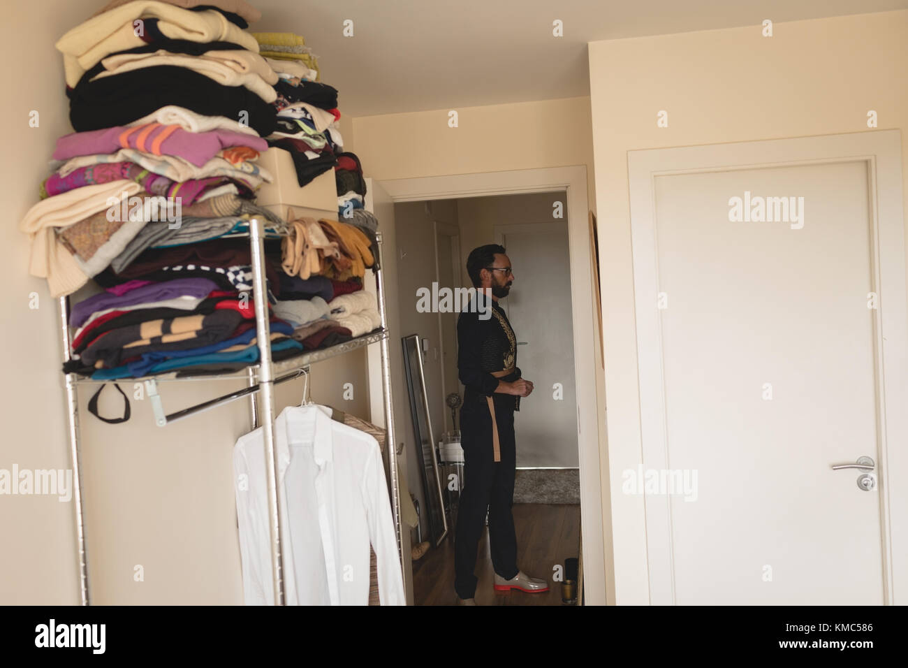 Man getting ready for work in bedroom Stock Photo - Alamy