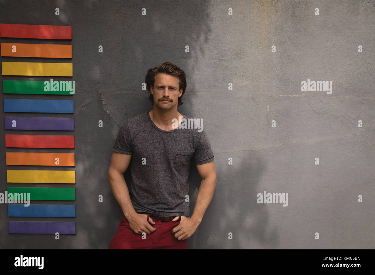 Man leaning on wall Stock Photo - Alamy