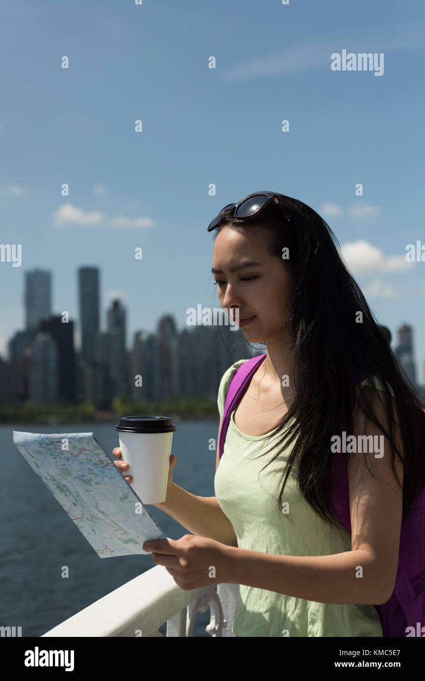 Asian woman reading a map in the ferry Stock Photo - Alamy