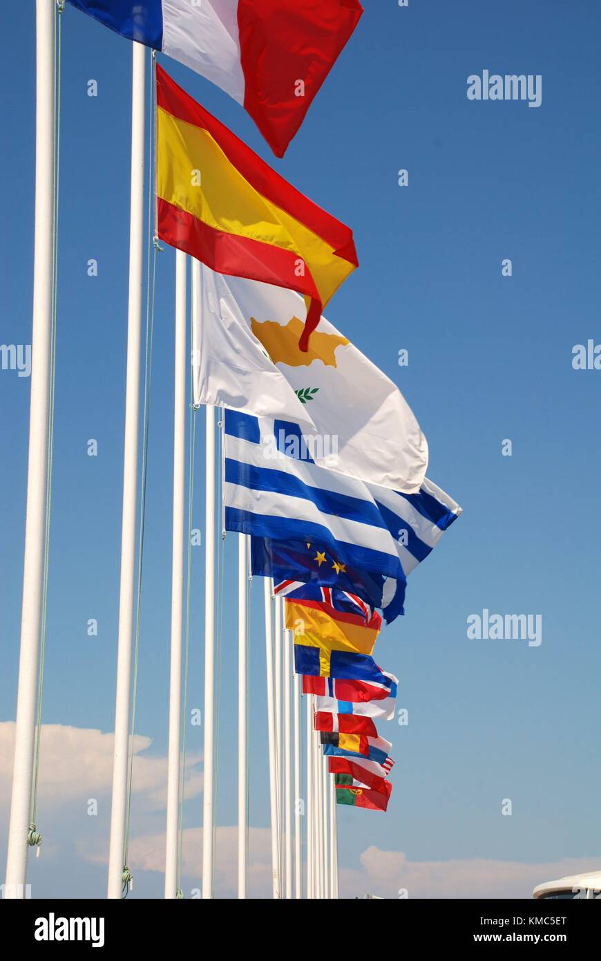 A row of various National flags flying at Mandraki harbour on the Greek ...