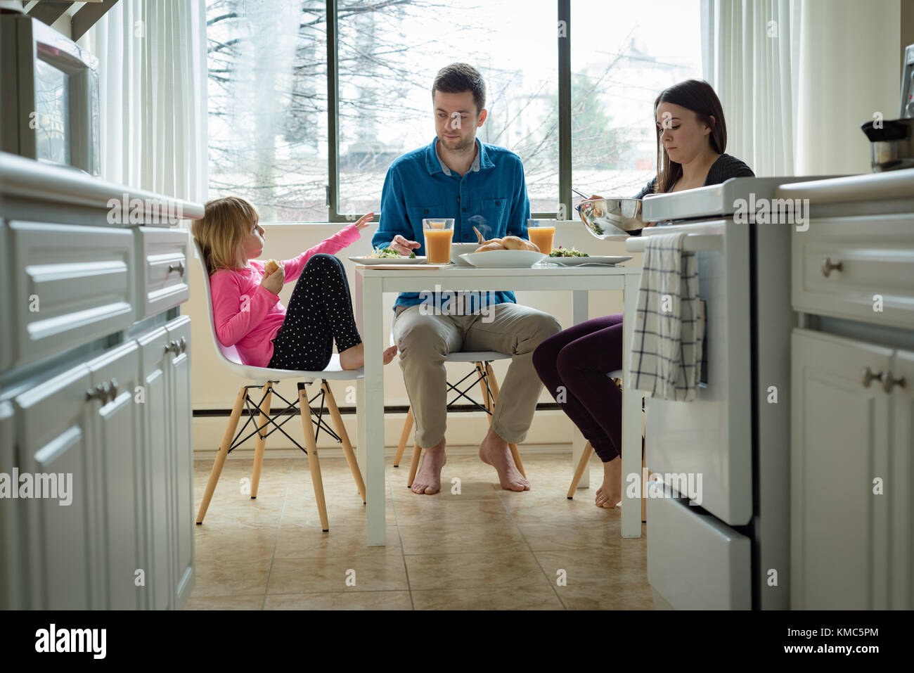 Family having breakfast in kitchen Stock Photo - Alamy