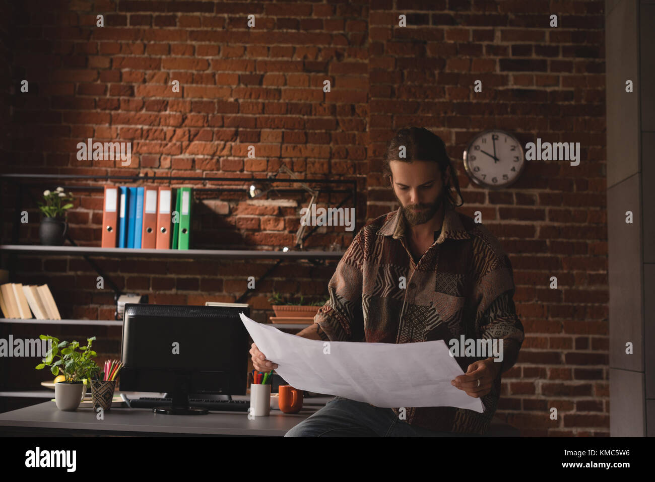 Man looking at chart Stock Photo - Alamy