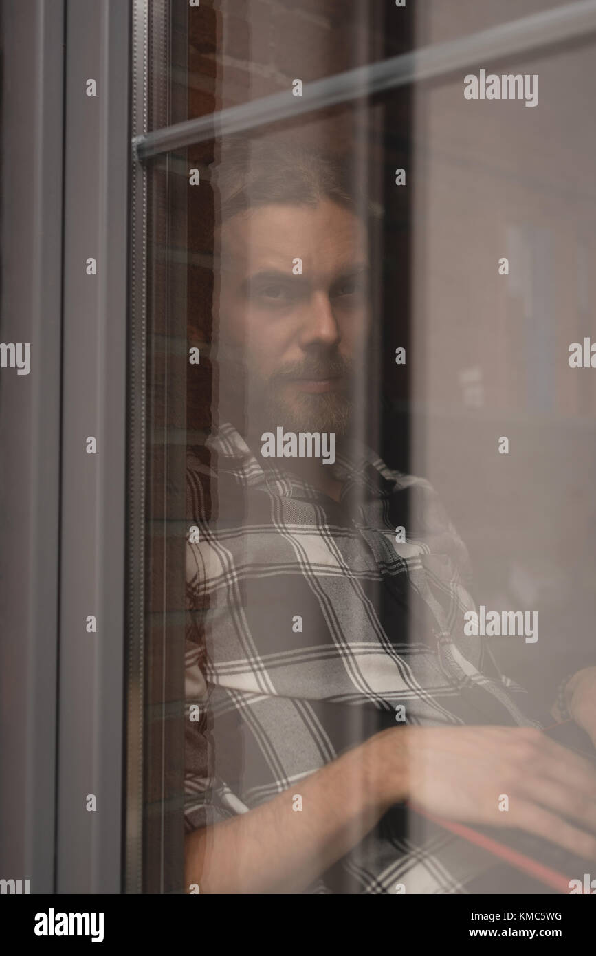 Man looking window Stock Photo - Alamy