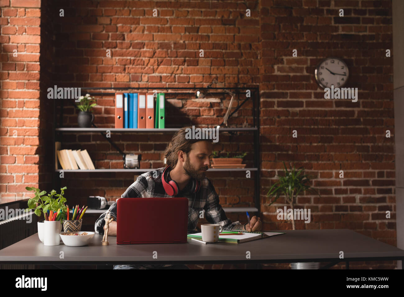 Man working at table Stock Photo - Alamy