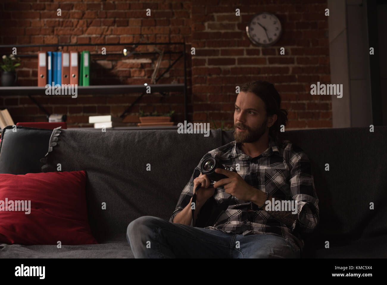 Man sitting with digital camera Stock Photo - Alamy