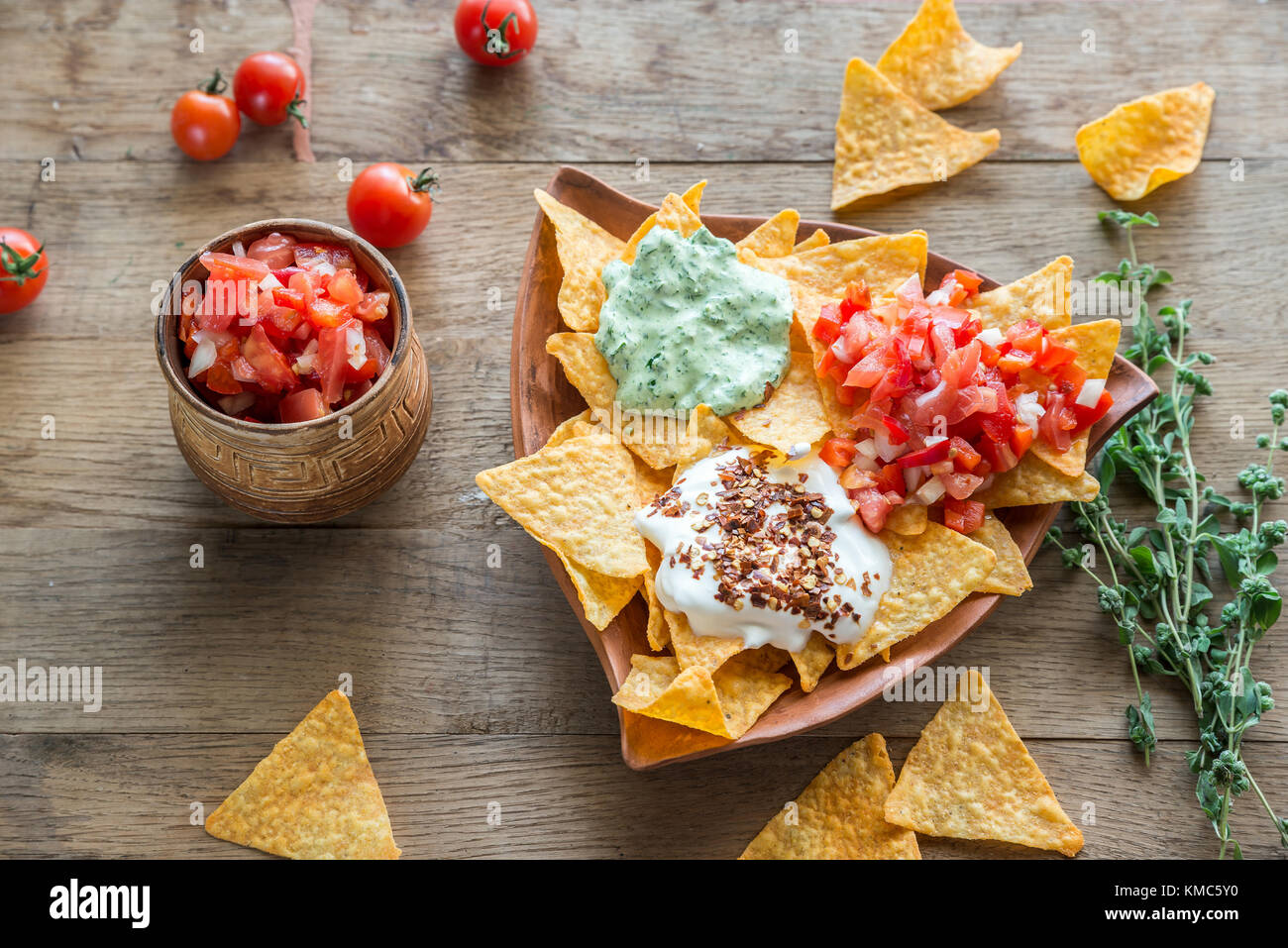 Cheese nachos with different types of sauce Stock Photo - Alamy