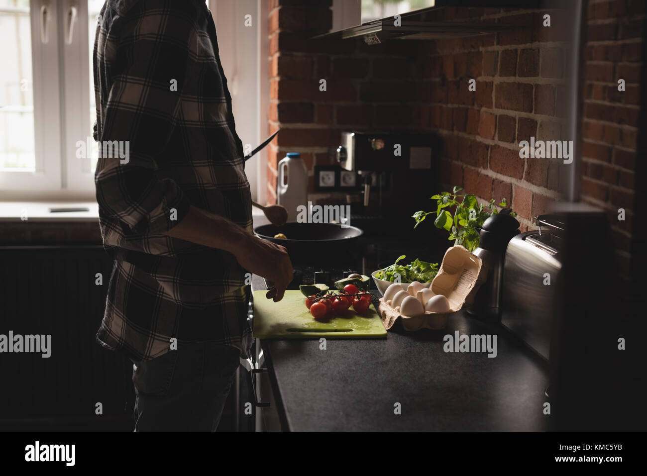 Man preparing food in kitchen Stock Photo - Alamy