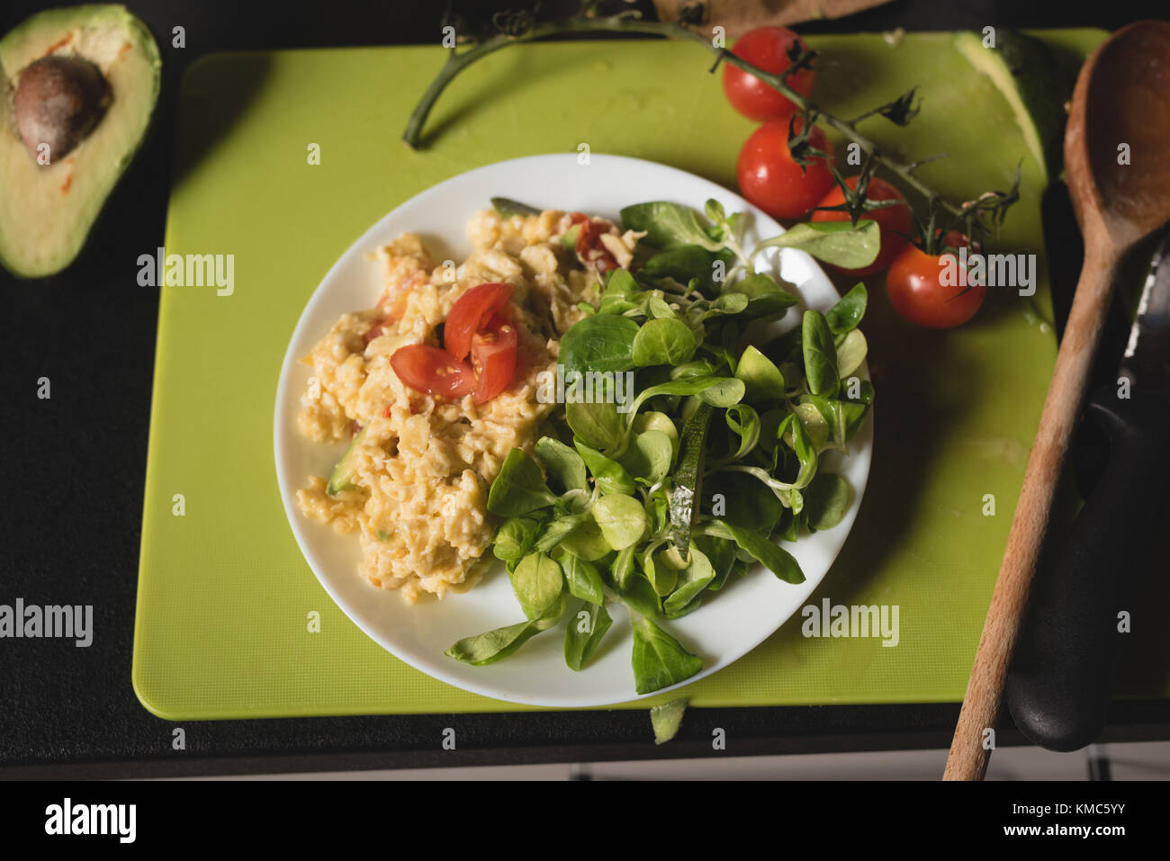 Scrambled eggs on plate in kitchen Stock Photo - Alamy