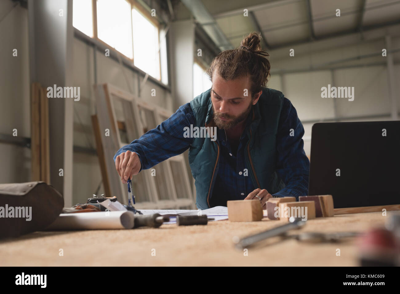 Carpenter drawing with compass on paper Stock Photo - Alamy