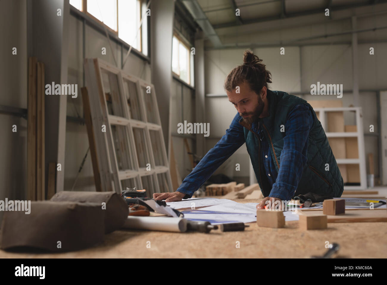Carpenter looking at chart Stock Photo - Alamy