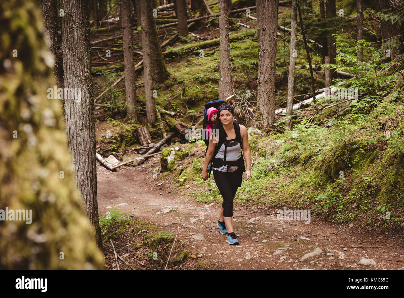 Mother carrying her baby in backpack carrier Stock Photo - Alamy