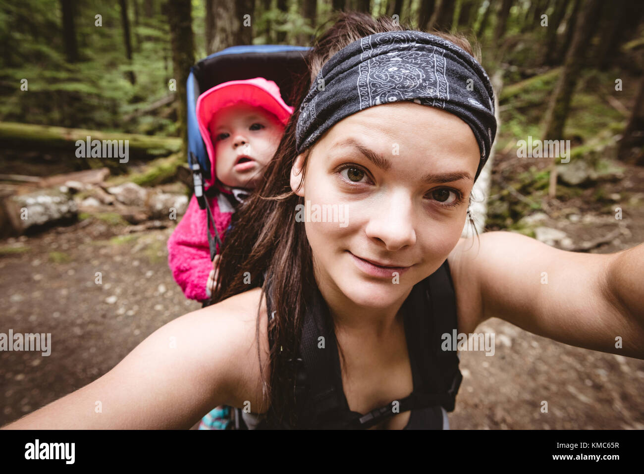 Mother carrying her baby in backpack carrier Stock Photo - Alamy