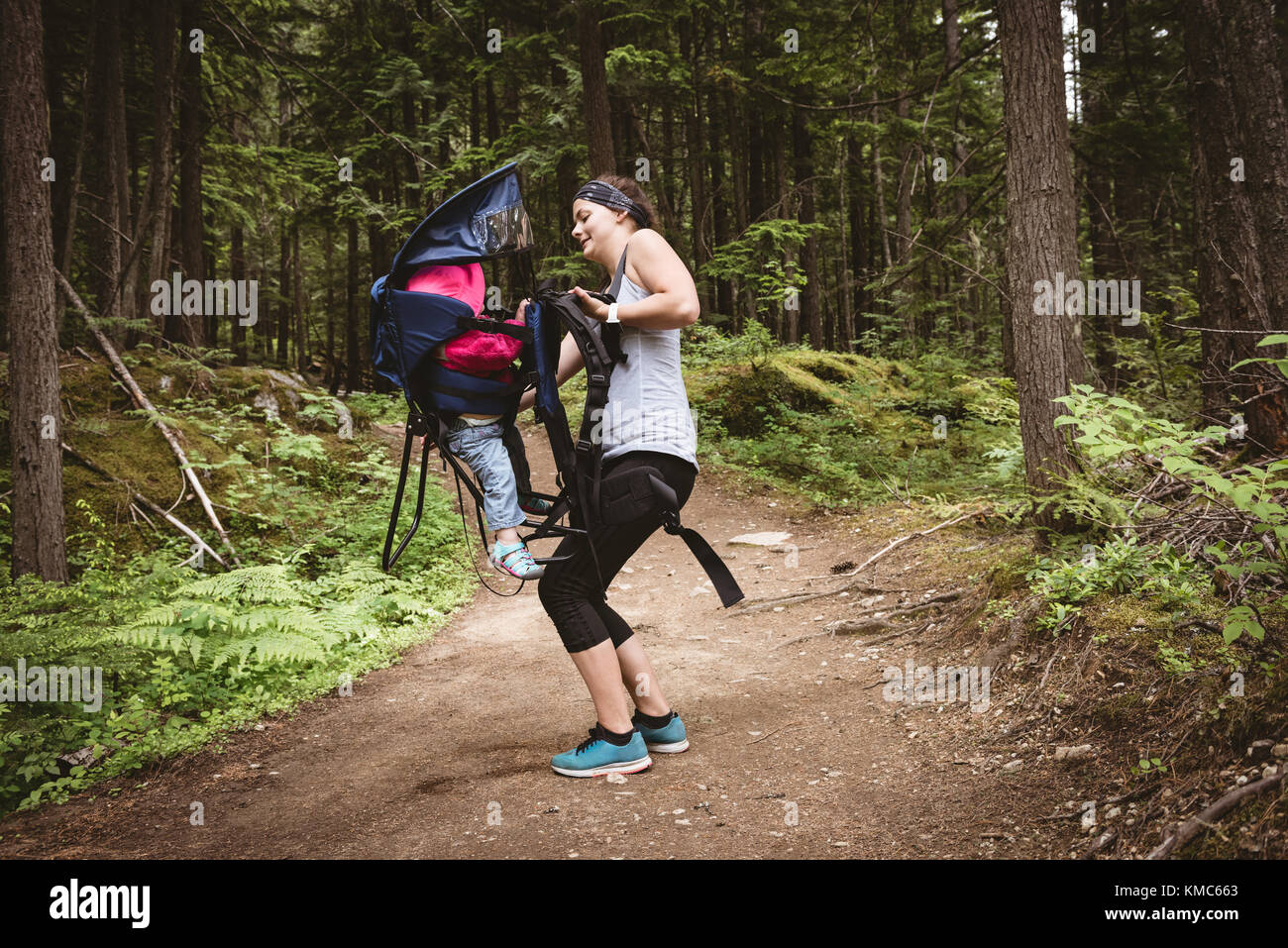 Mother carrying her baby in backpack carrier Stock Photo - Alamy