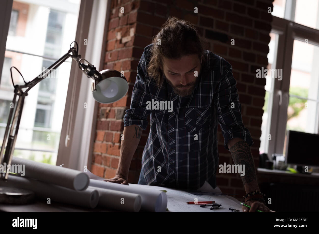 Male graphic designer working on blueprint Stock Photo - Alamy