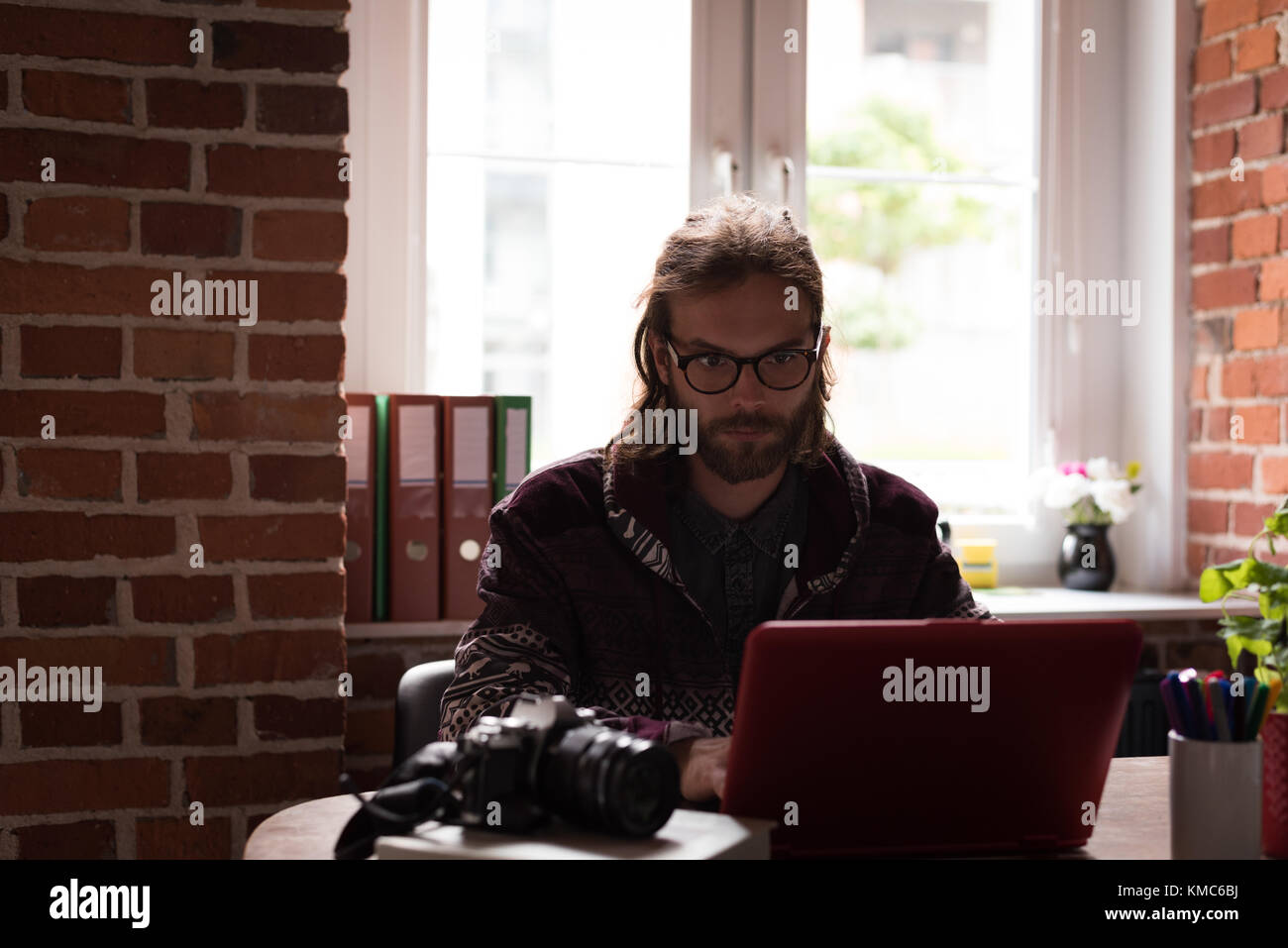 Male graphic designer working on laptop Stock Photo - Alamy