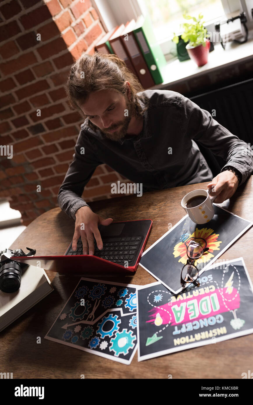 Male graphic designer working on laptop Stock Photo - Alamy
