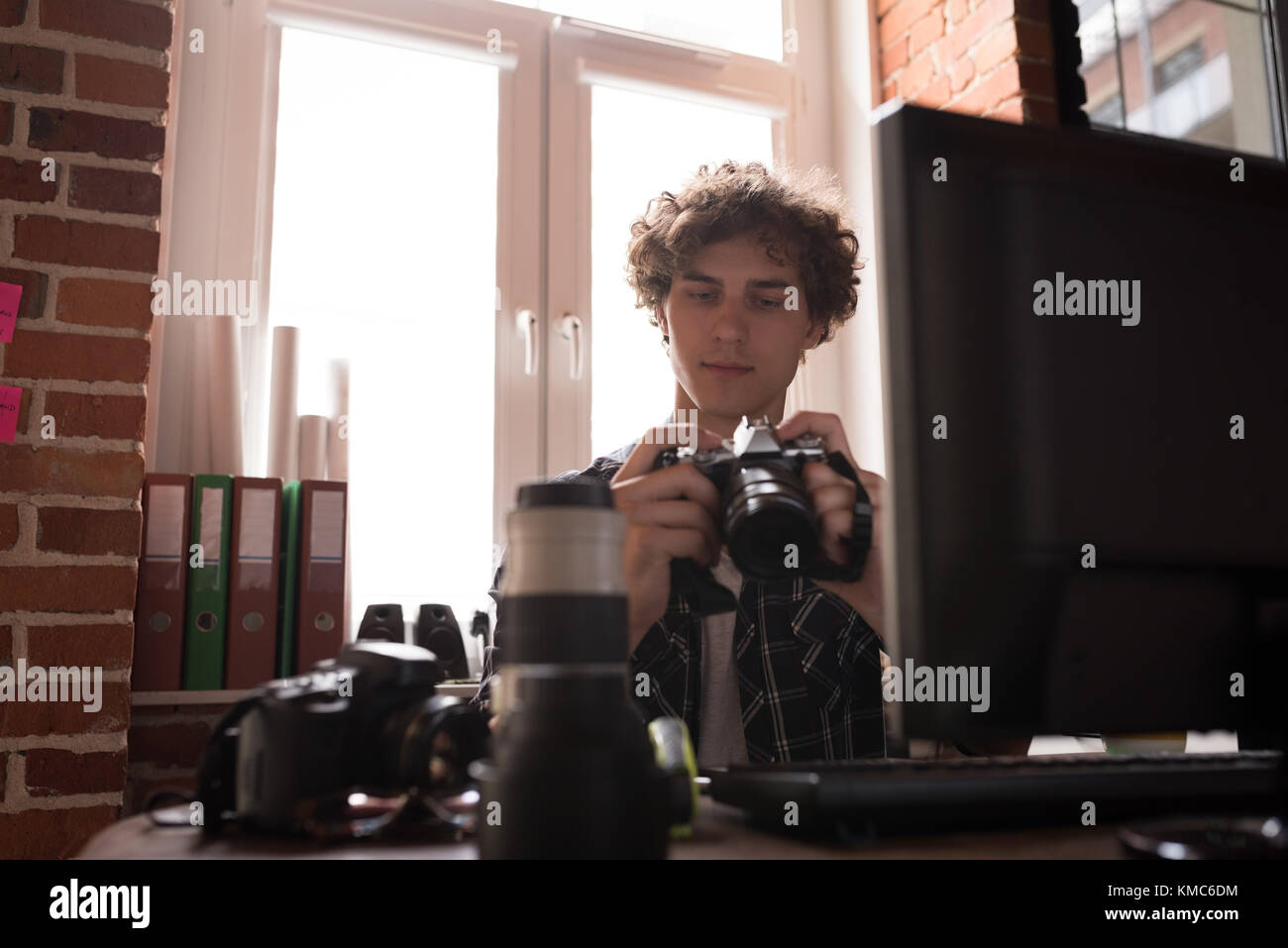 Male graphic designer using camera Stock Photo - Alamy