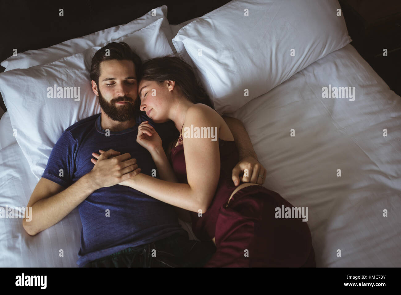 Sleeping couple in bed embracing hi-res stock photography and images ...