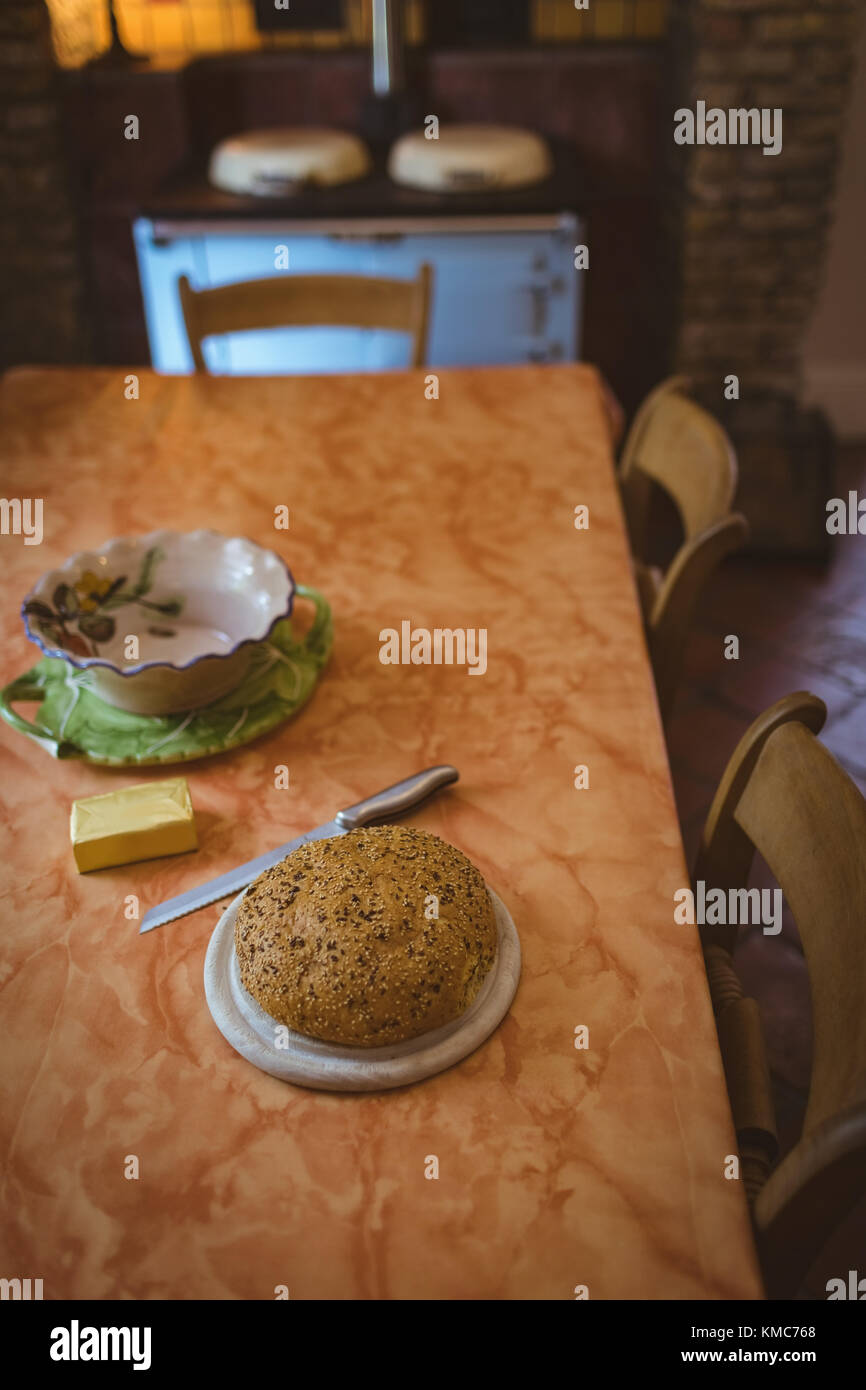 Bun with knife on dining table Stock Photo - Alamy