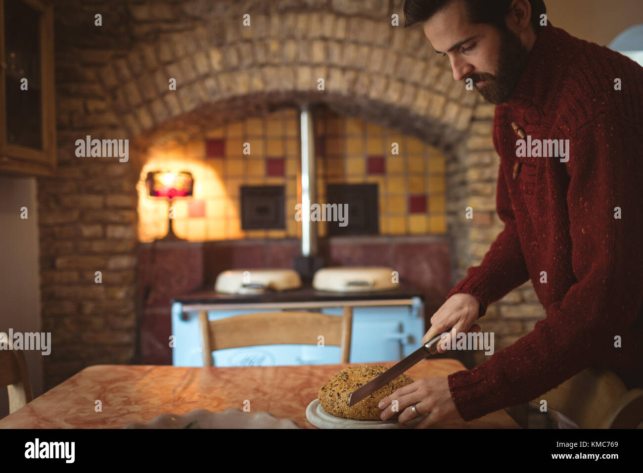 Man cutting bun with knife Stock Photo - Alamy