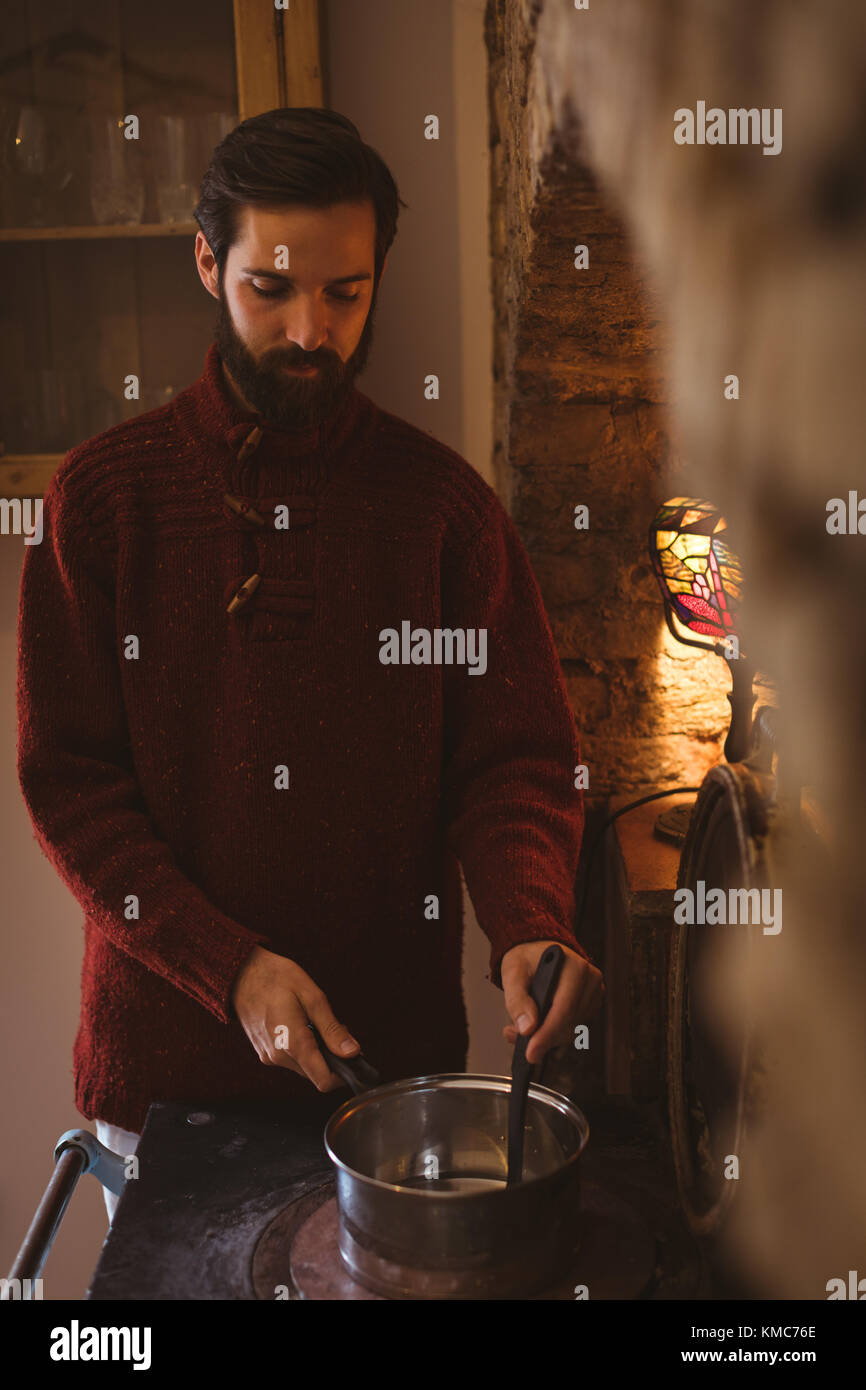 Man cooking food in kitchen Stock Photo - Alamy
