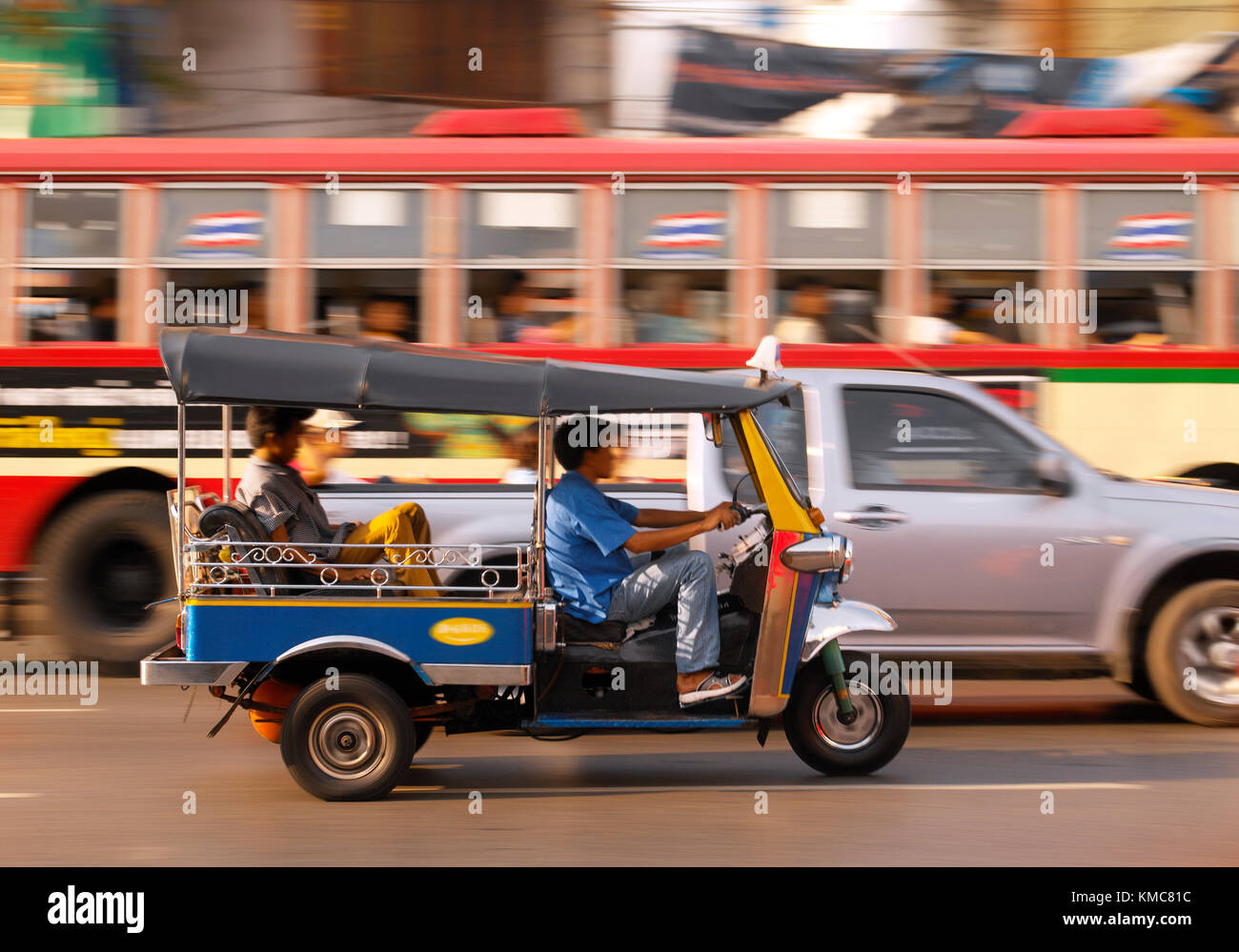 A tuk tuk travels at high speed through the chaotic traffic of Bangkok ...