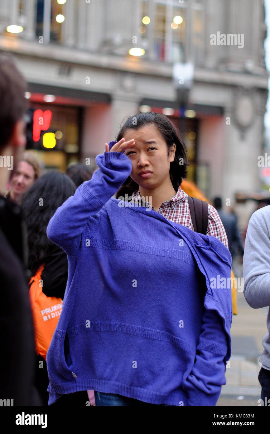 Chinese Woman Wearing Cardigan Wrong Way Round In London England UK Stock Photo Alamy