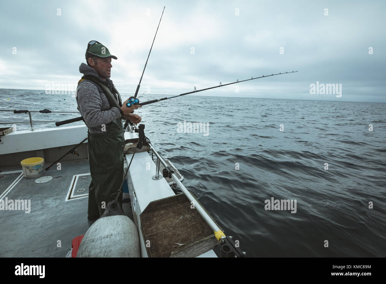 Fisherman fishing from the boat Stock Photo - Alamy