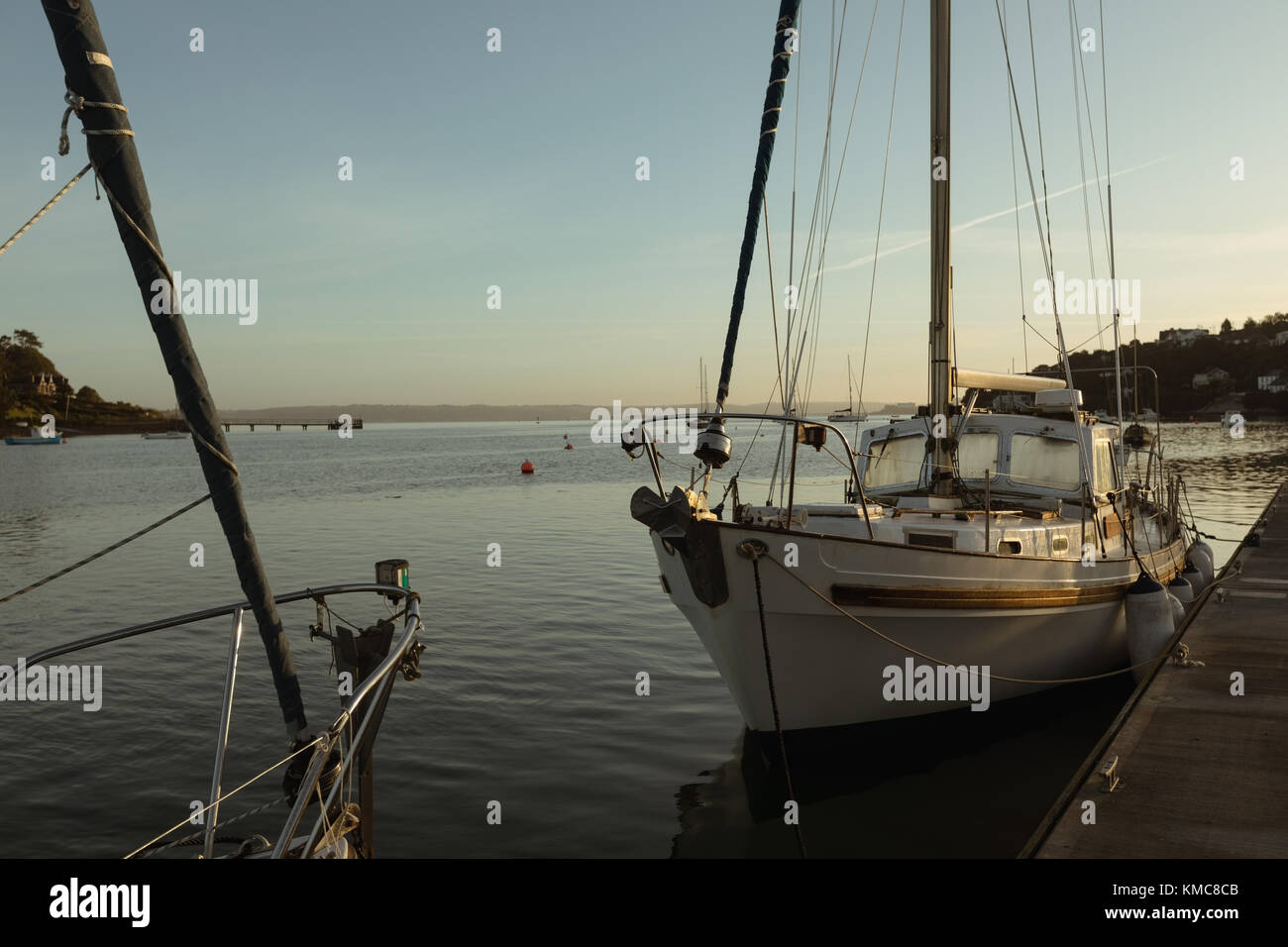 Moored boat near jetty at harbor Stock Photo - Alamy