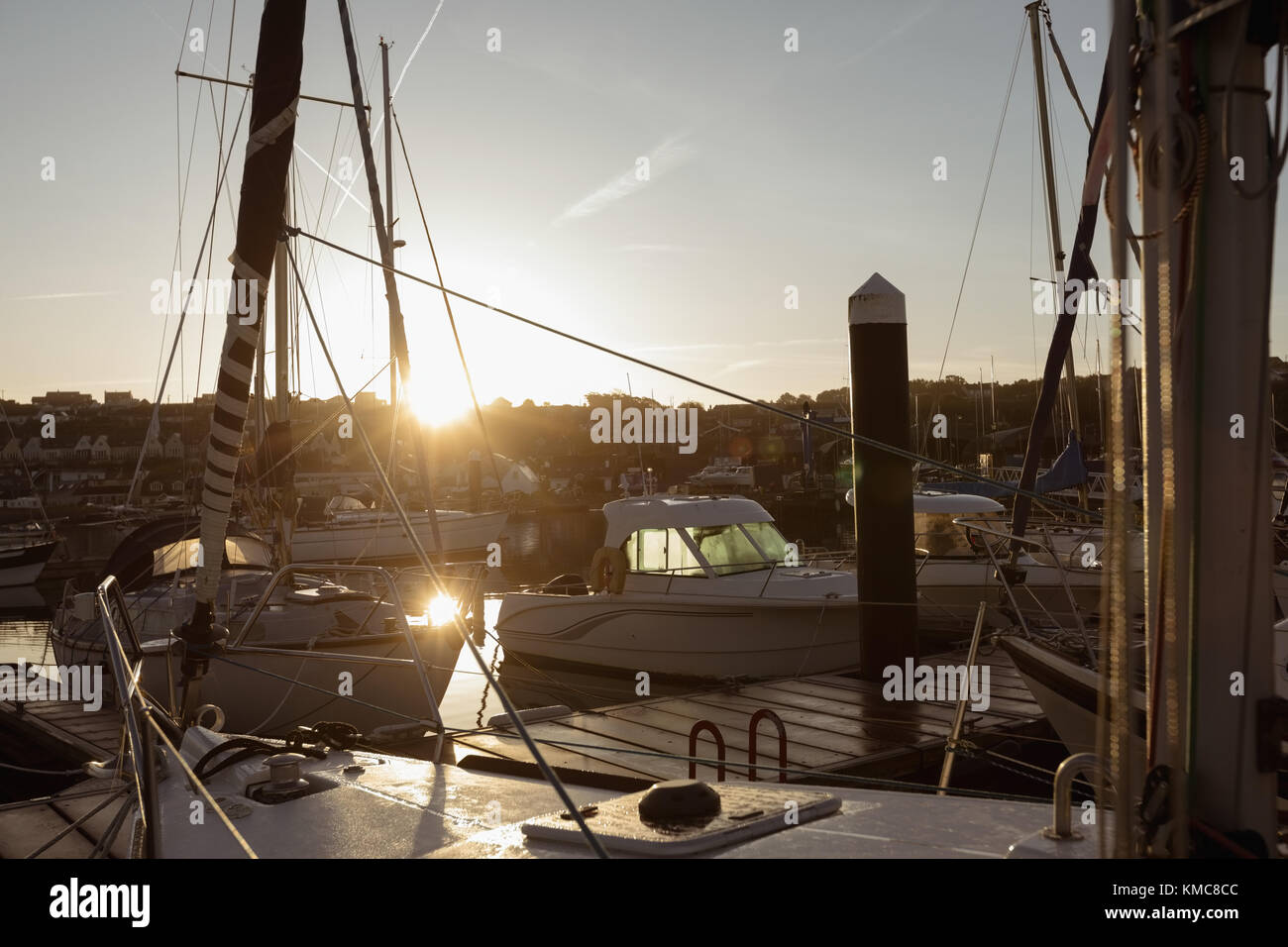 Moored boat and empty jetty at harbor Stock Photo - Alamy