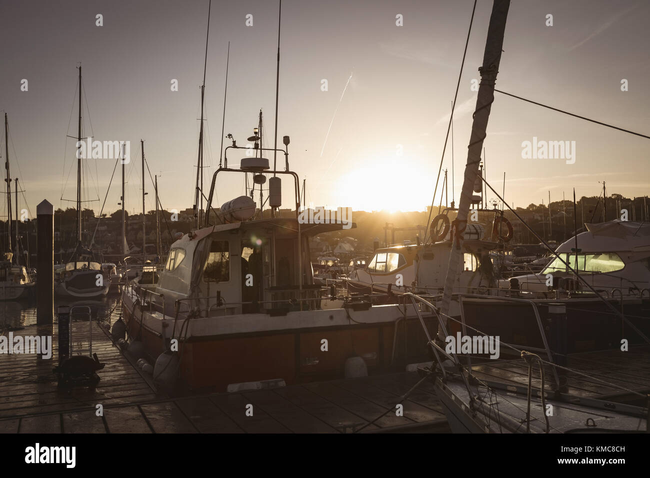 Moored boat near jetty at harbor Stock Photo - Alamy