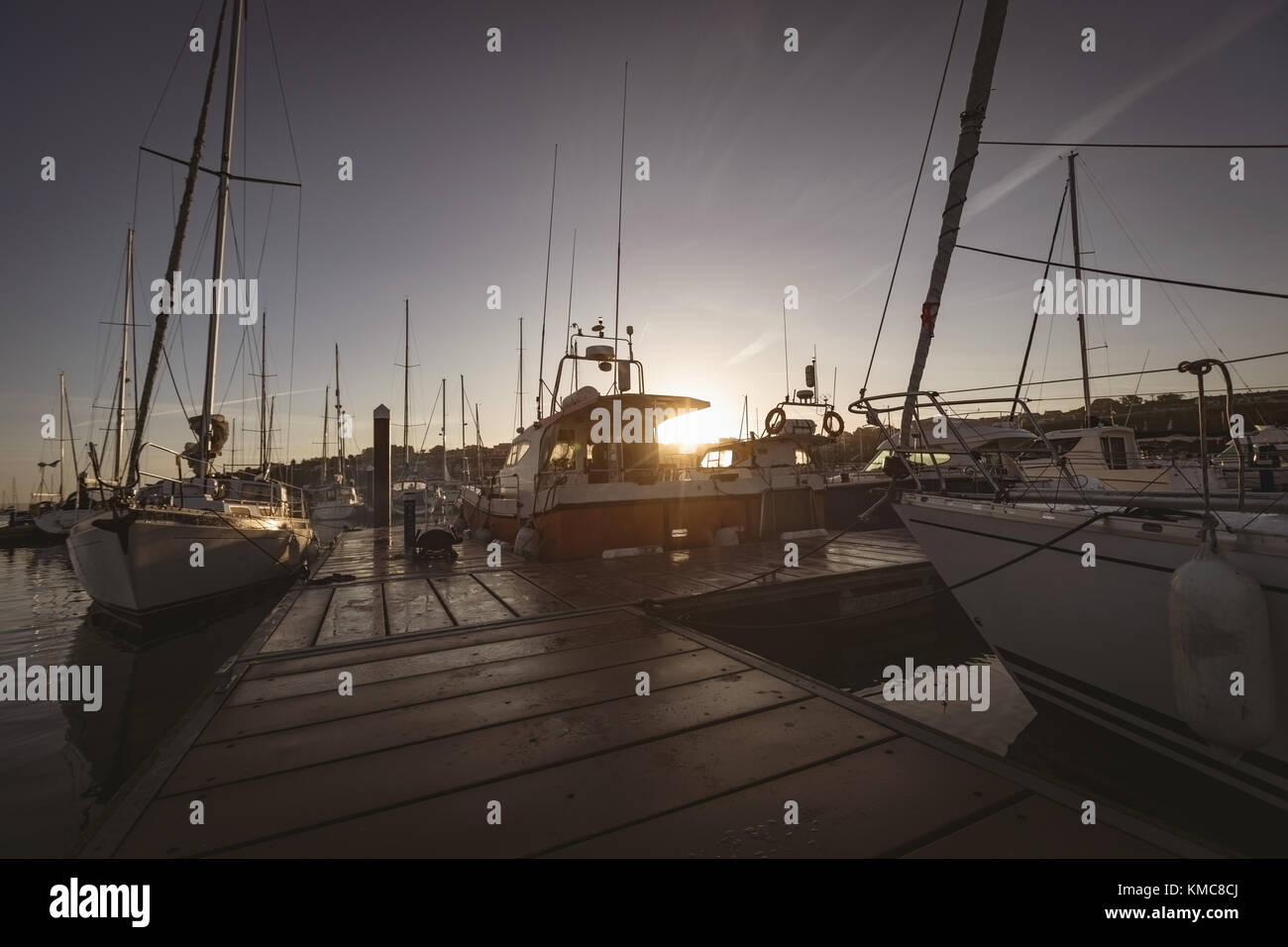 Moored boat near jetty at harbor Stock Photo - Alamy