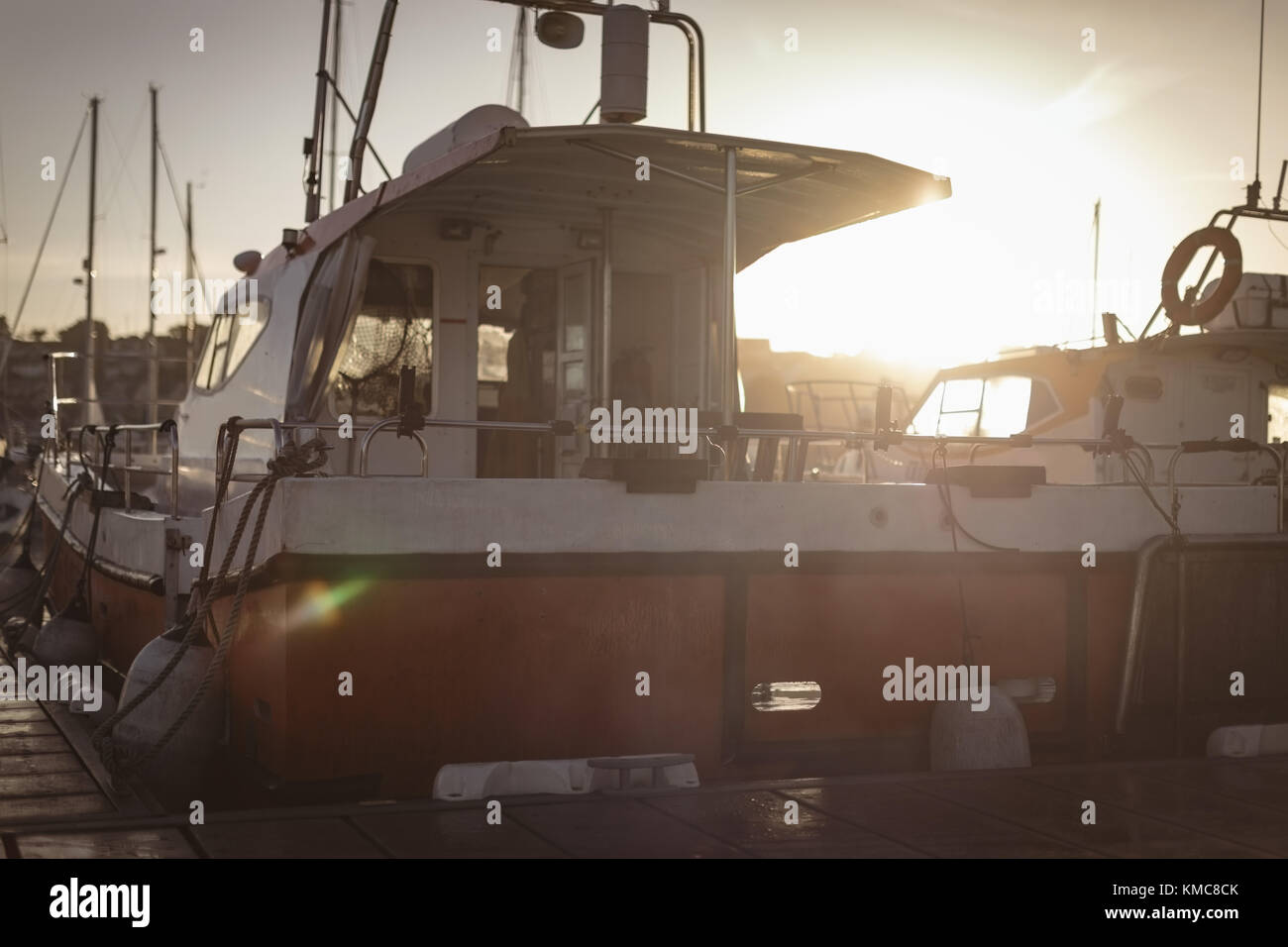 Moored boat and empty jetty at harbor Stock Photo - Alamy