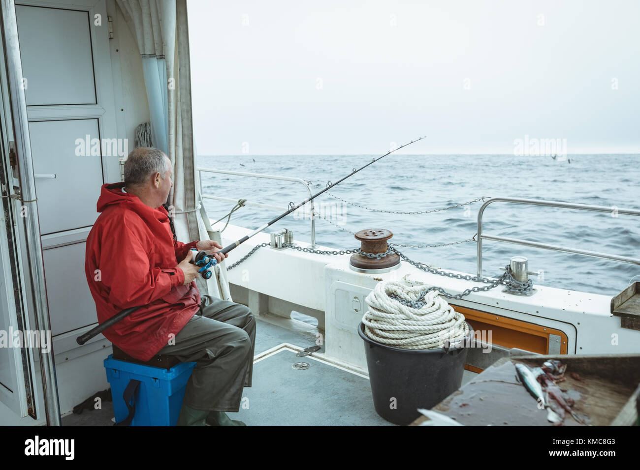 Fisherman fishing from the boat Stock Photo - Alamy