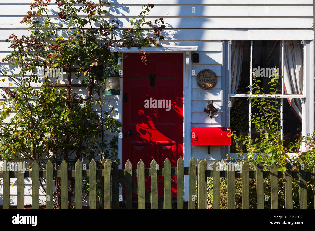A pretty red front door of a weatherboard cottage house Stock Photo - Alamy