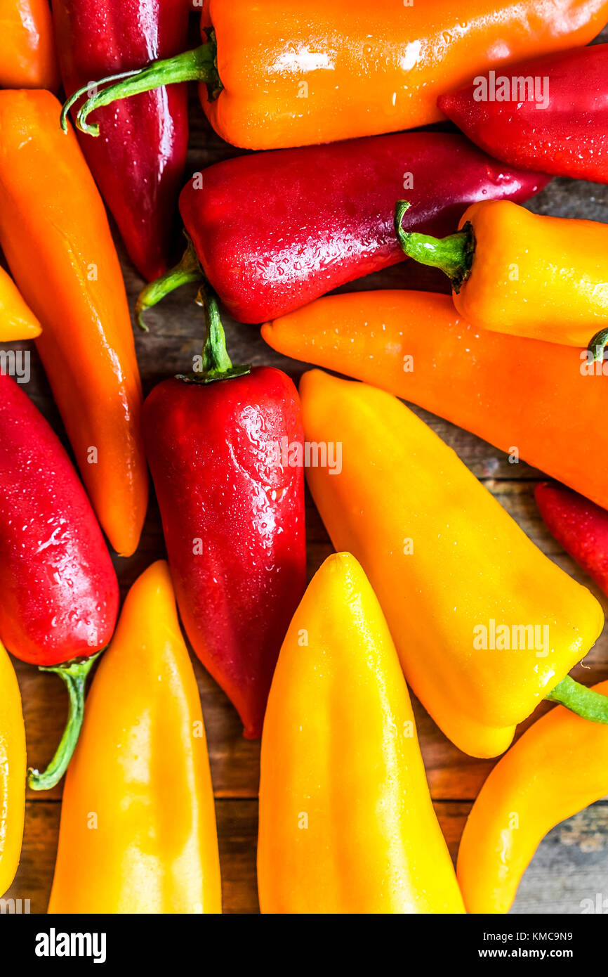 Colorful peppers on rustic background Stock Photo - Alamy
