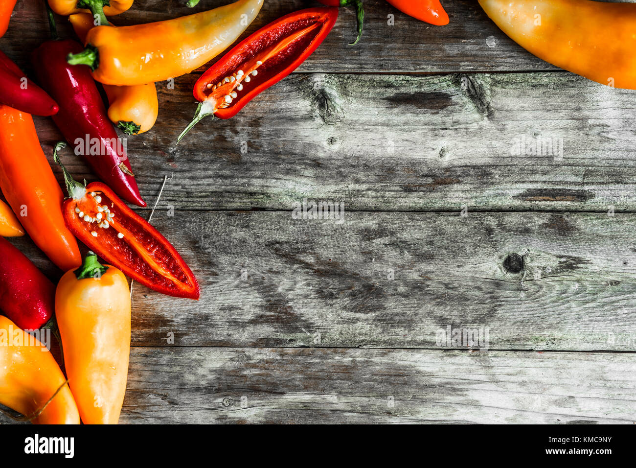 Colorful peppers on rustic background Stock Photo - Alamy