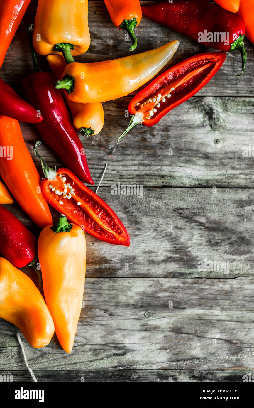 Colorful peppers on rustic background Stock Photo - Alamy